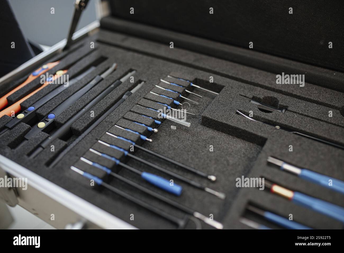 Compact case showcasing organized surgical instruments with blue ...