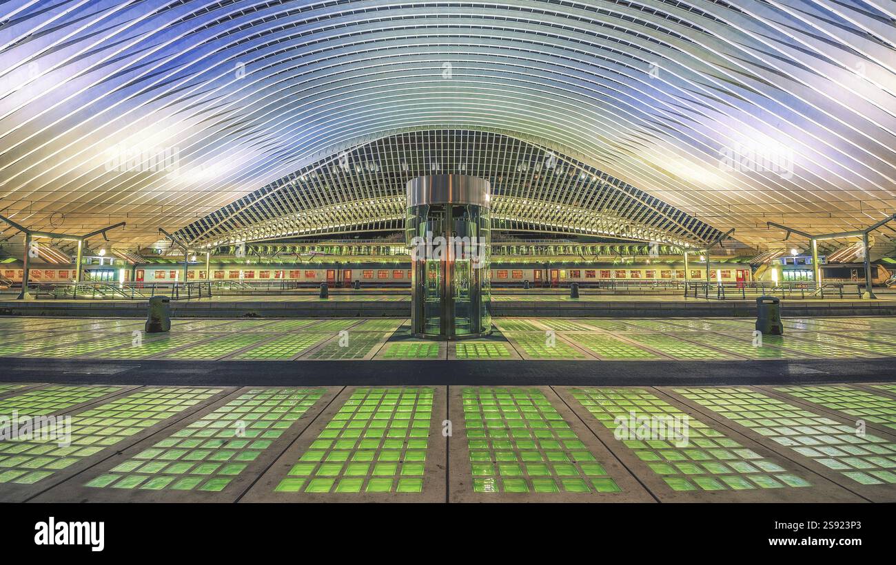 Interior view of a railway station with green illuminated floor and ...