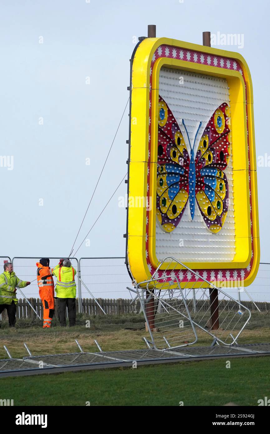 Workers secure boards from the wind as Storm Eowyn hits the country in ...