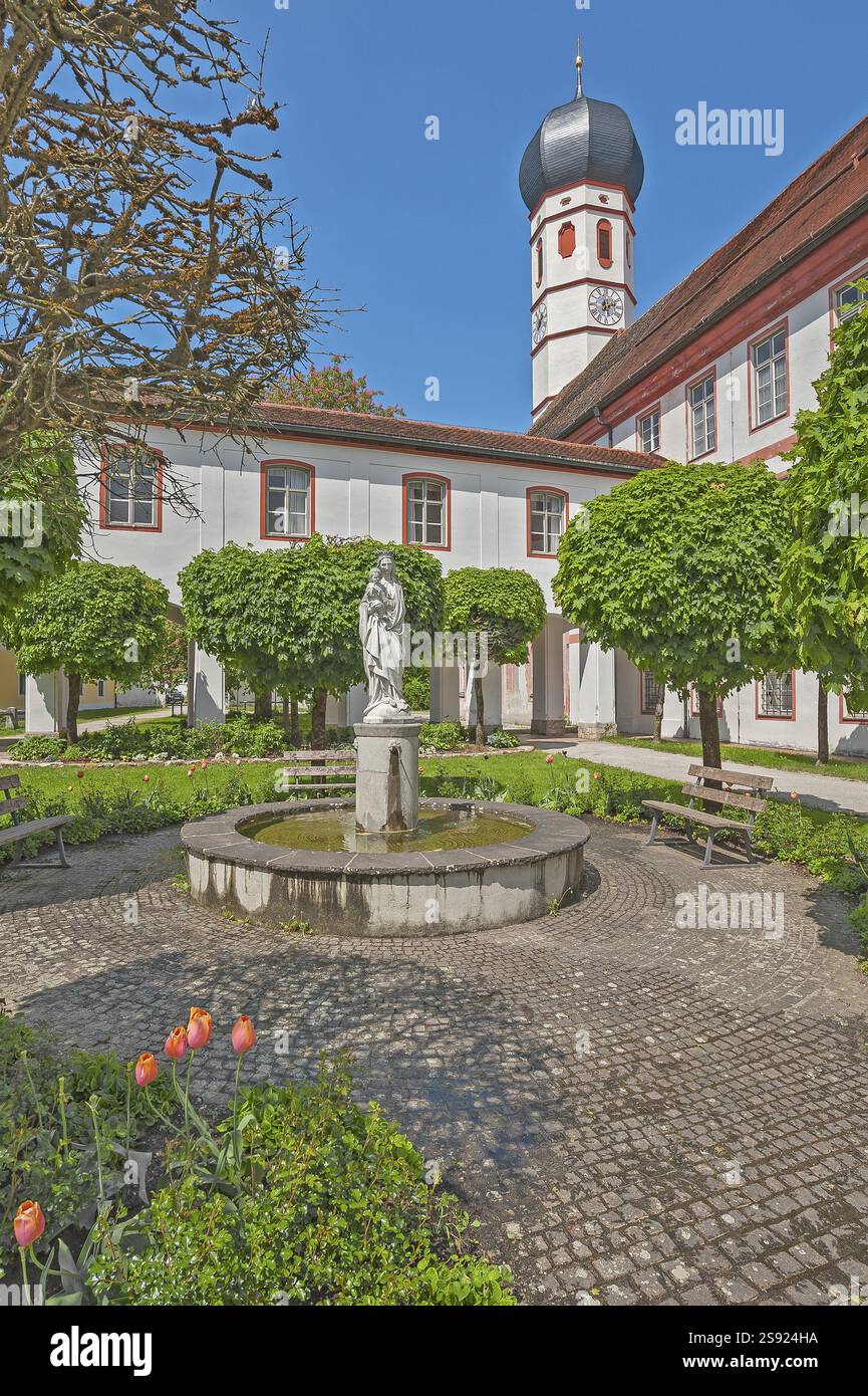 Beuerberg Monastery with onion dome and fountain with statue of the ...