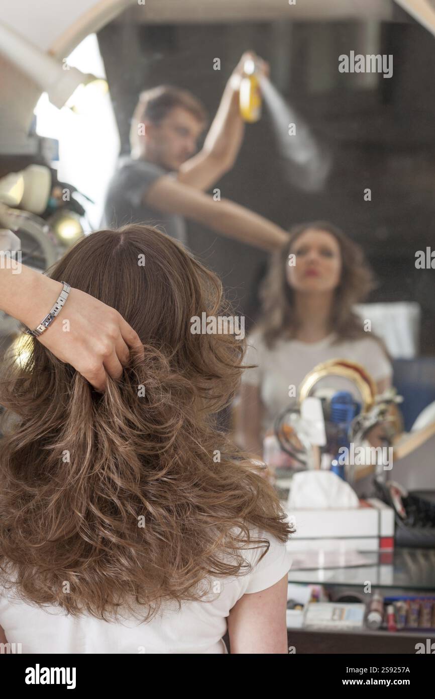 Professional hairdresser with long hair model. Professional hair care ...