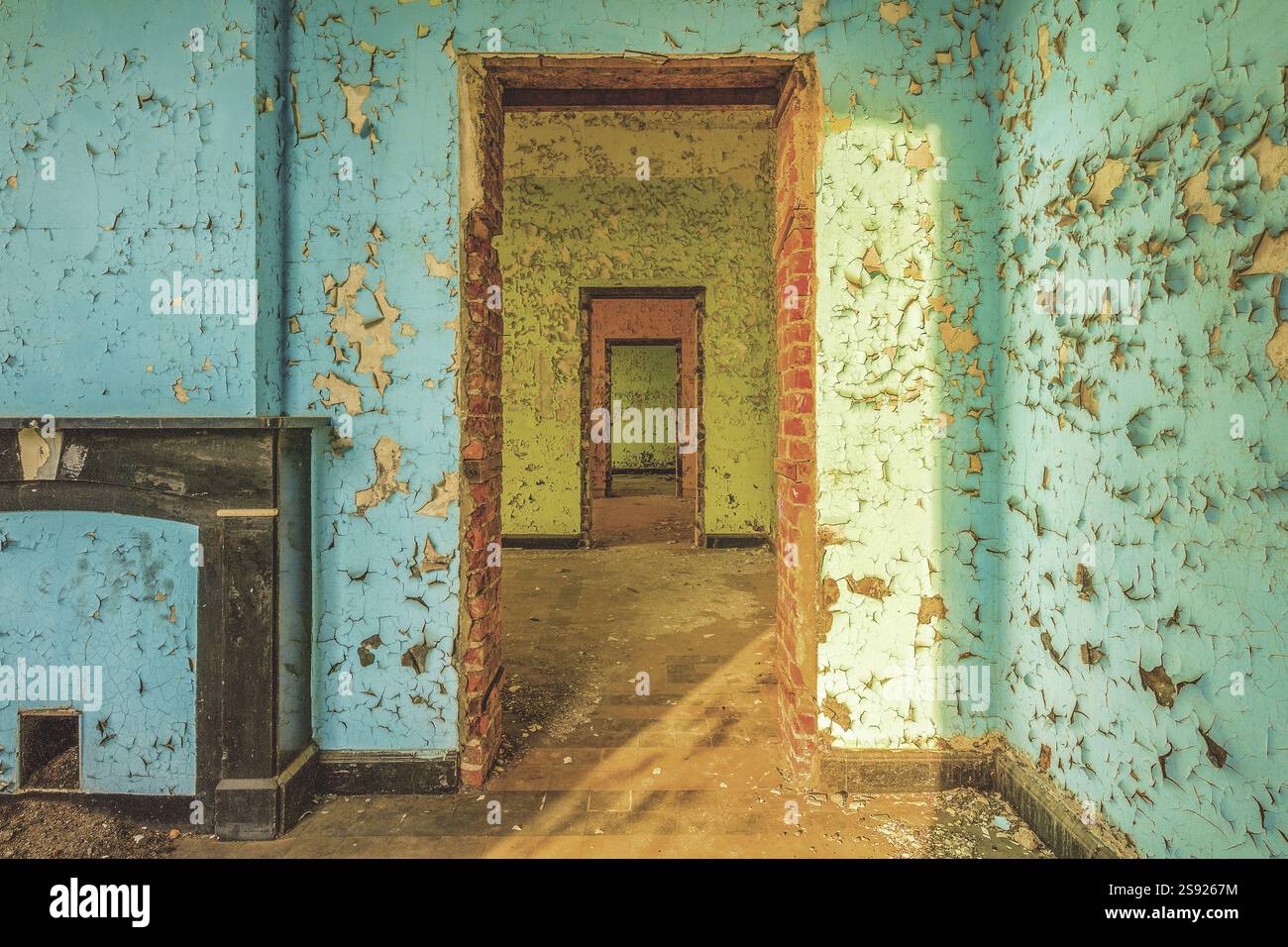 An abandoned room with peeling paint and a view through several doors, Prison H11, Lost Place ...