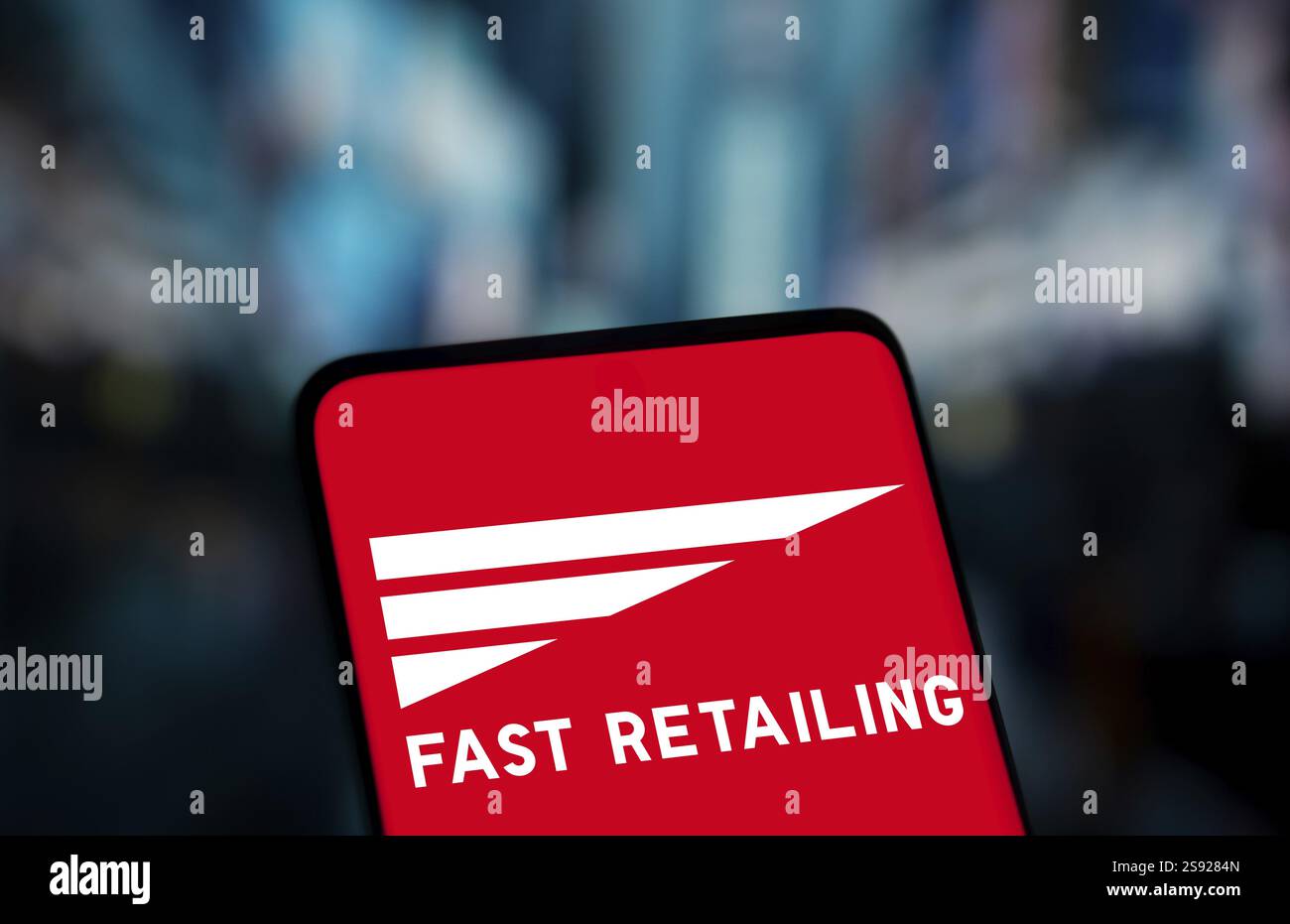 Dhaka, Bangladesh- 28 Nov 2024: Fast Retailing logo is displayed on smartphone.Fast Retailing Co ...