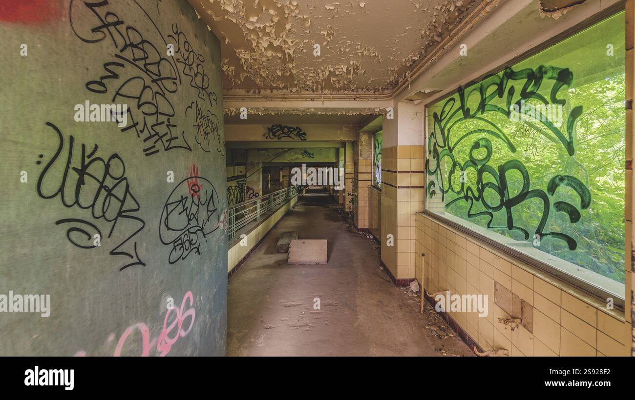 Artistically designed abandoned corridor with graffiti and decaying ...