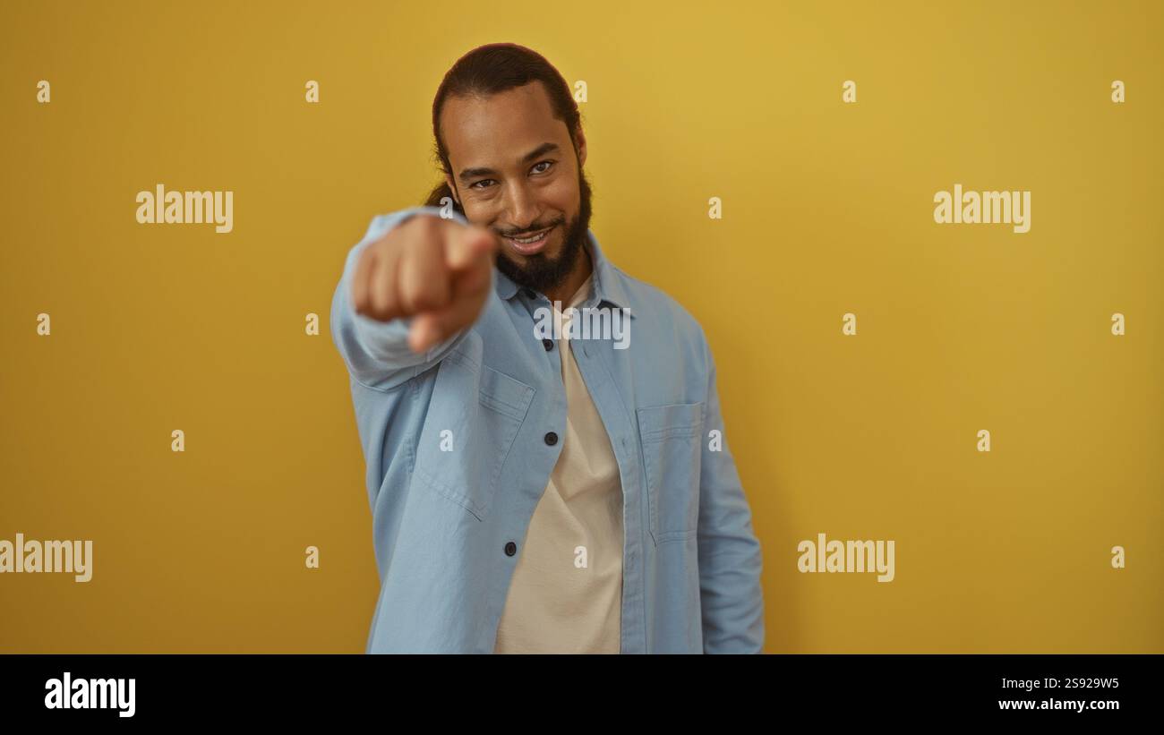 Arab man pointing confidently against isolated yellow background ...