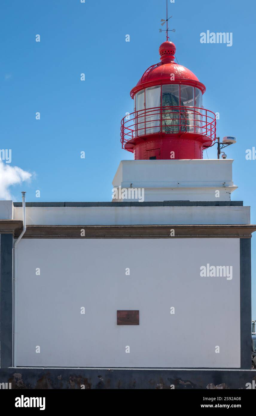 Building of a lighthouse with white facade and red tower. Located on a ...