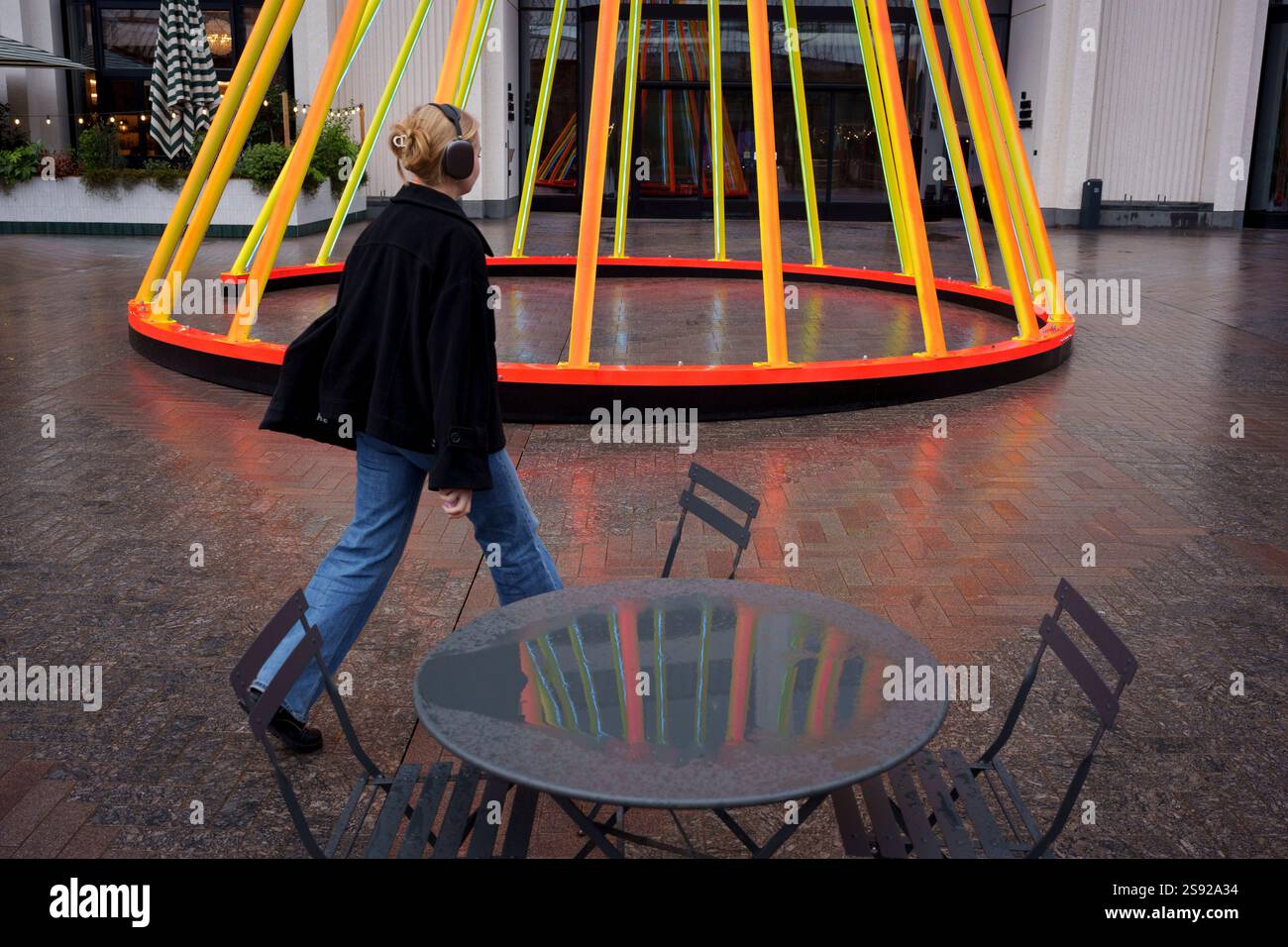 Members of the public pass an illuminated sculpture at Lewis Cubitt ...