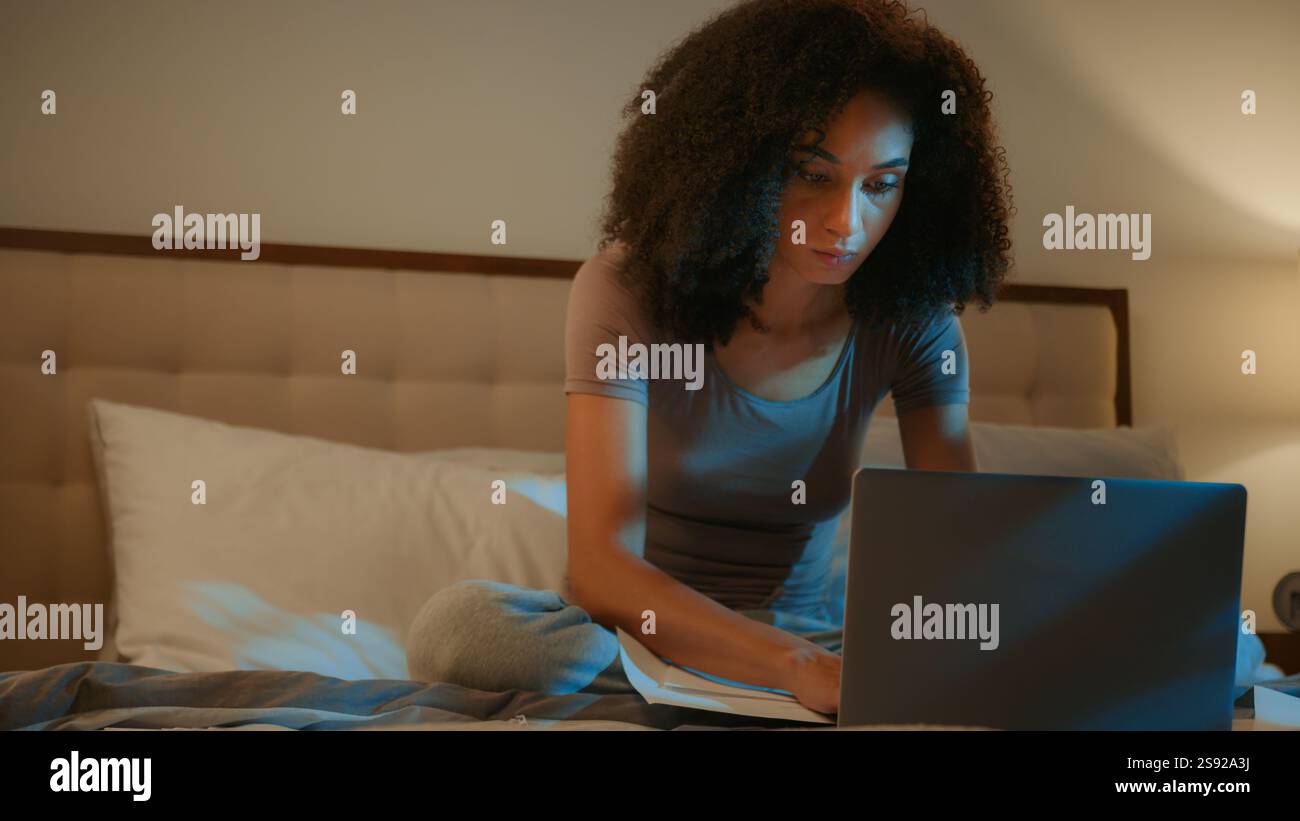 African American woman businesswoman working from home paperwork laptop ...