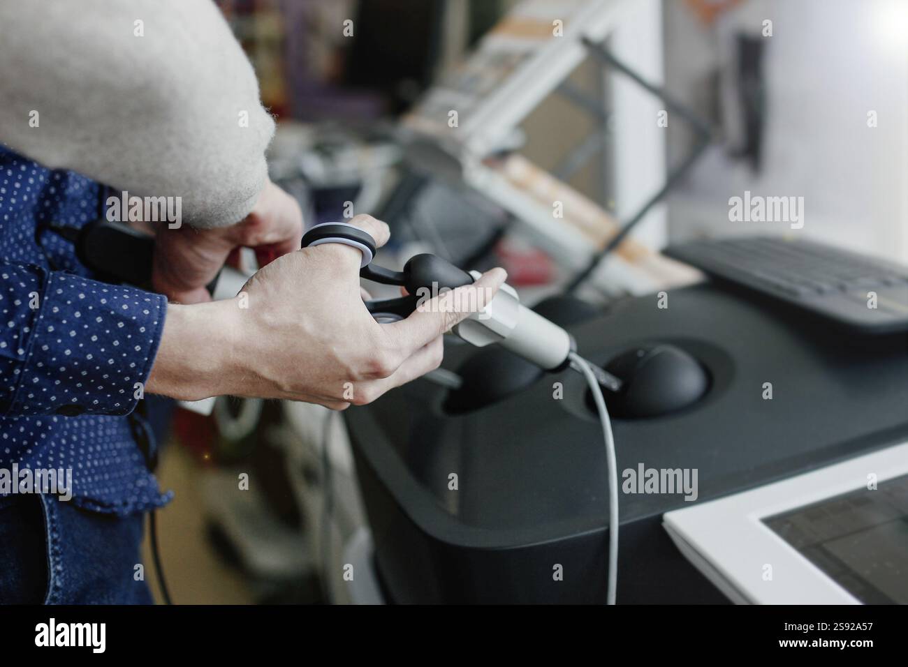 Hands engaging with laparoscopic simulation equipment for training ...
