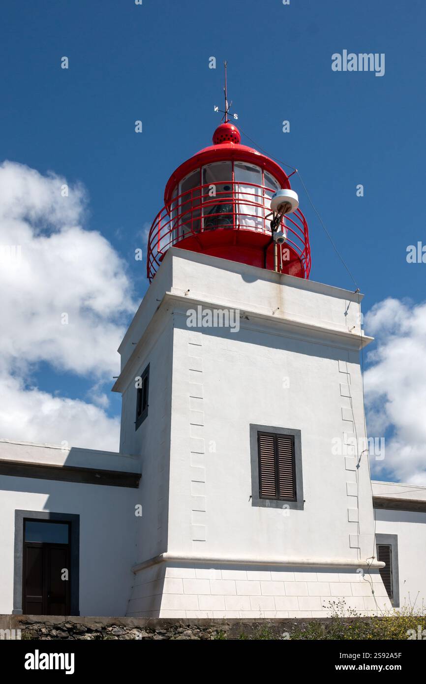 Building of a lighthouse with white facade and red tower. Located on a ...
