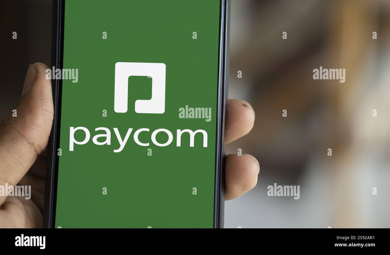 Dhaka, Bangladesh- 19 Jan 2025: paycom logo is displayed on smartphone ...