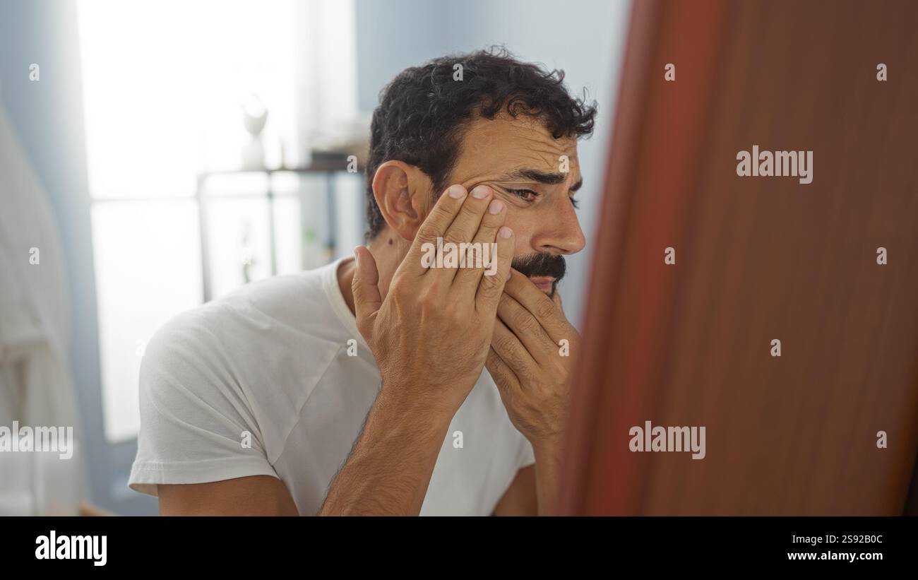 Hispanic man with a beard in a spa, examining his reflection in a ...