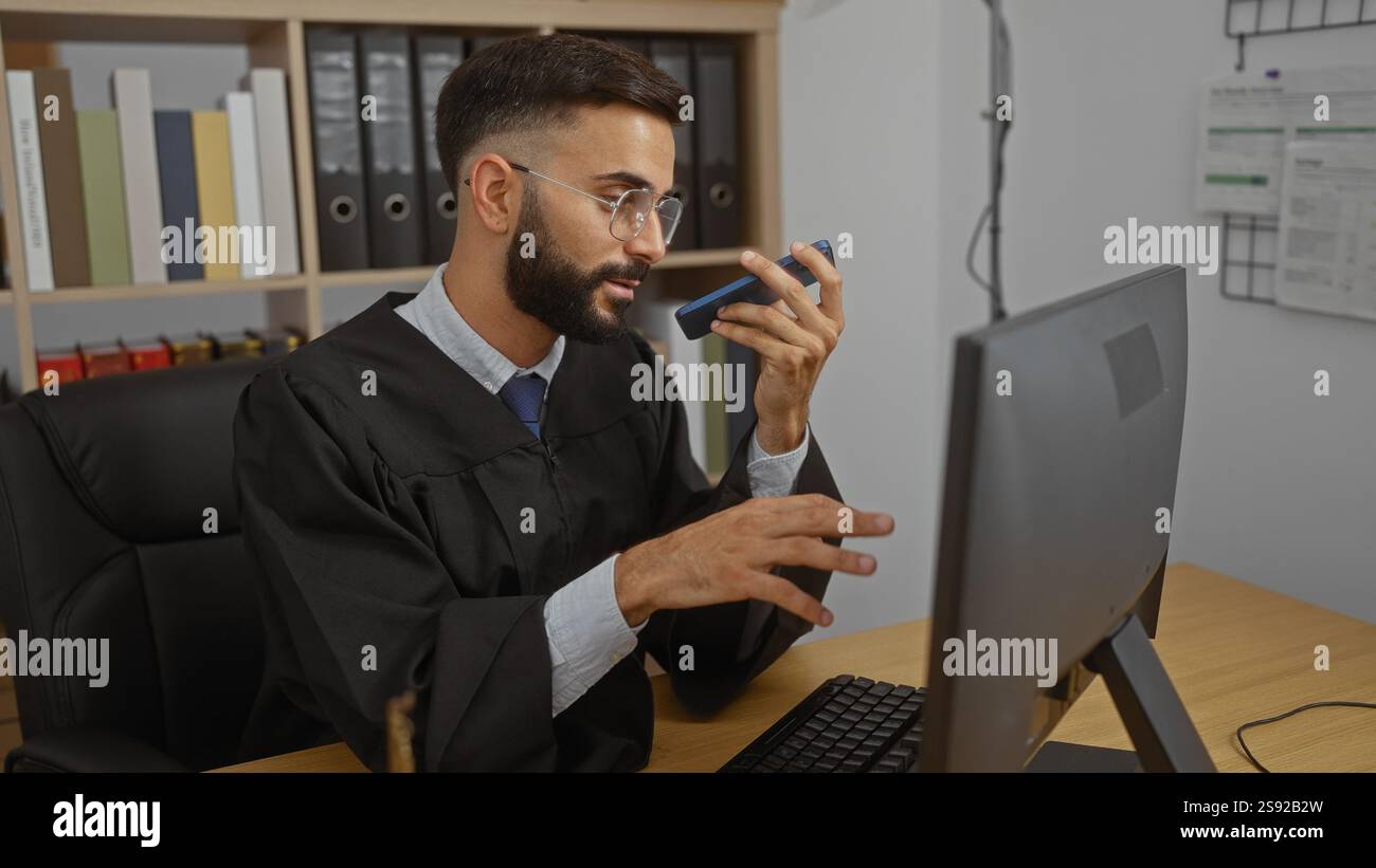 Young hispanic man in judge attire working in his office, speaking into ...