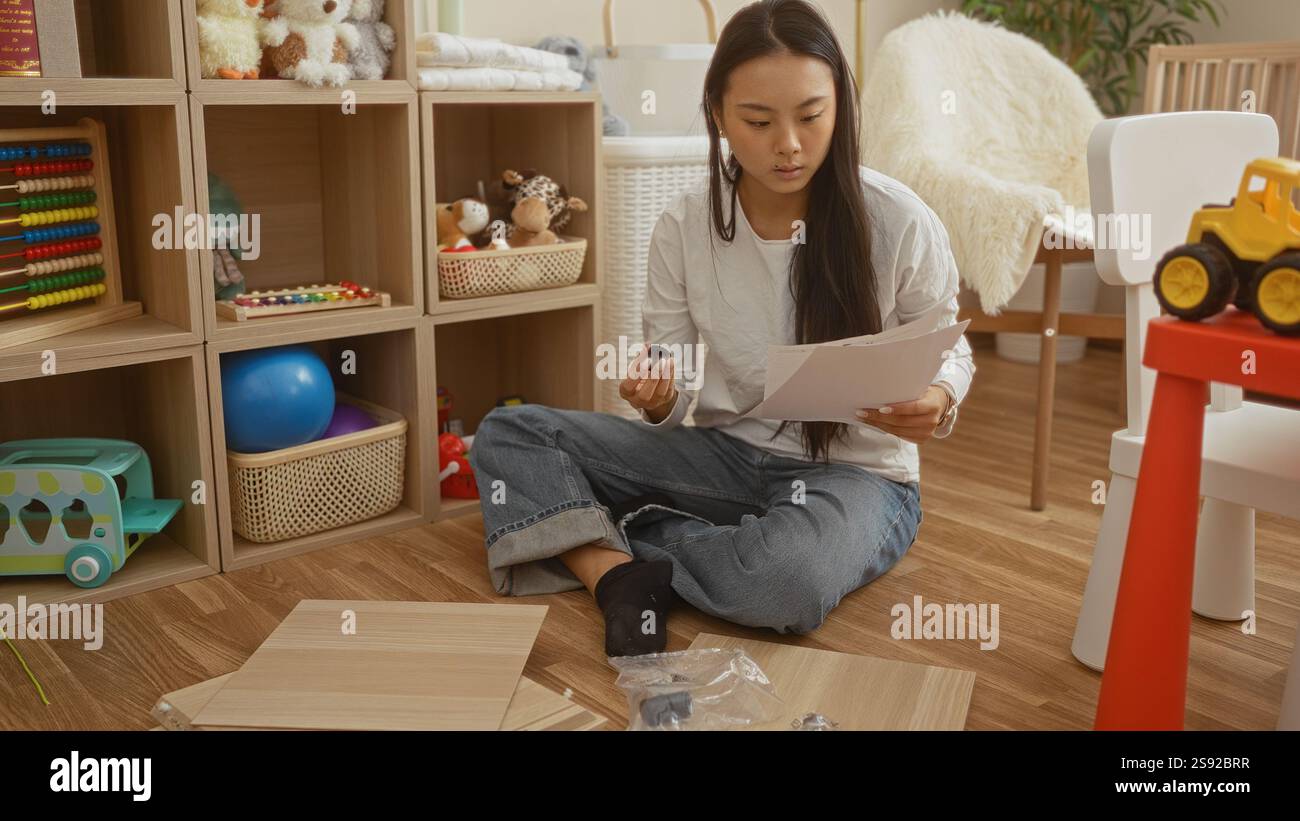 Woman assembling furniture in a cozy living room with toys and shelves ...