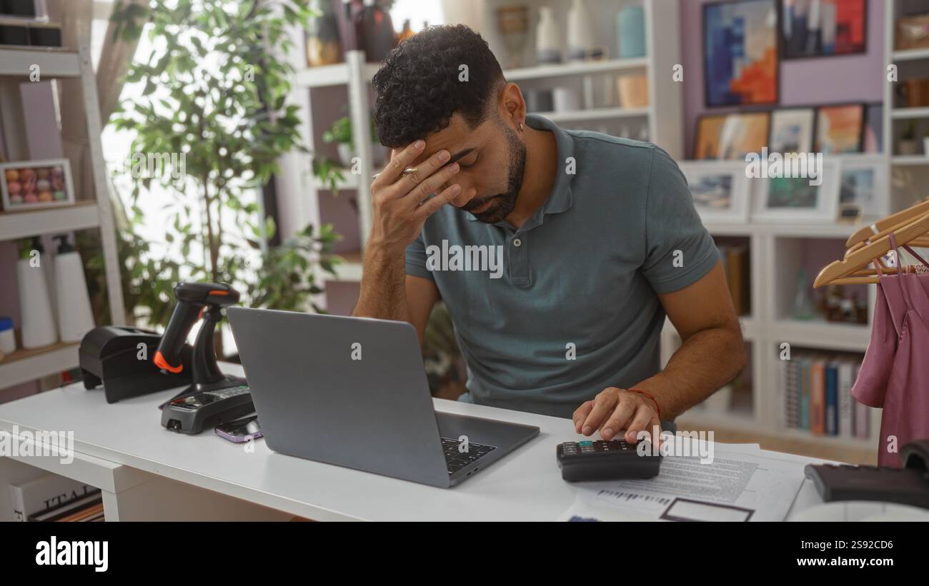 Young man calculating expenses indoors while working in home decor ...
