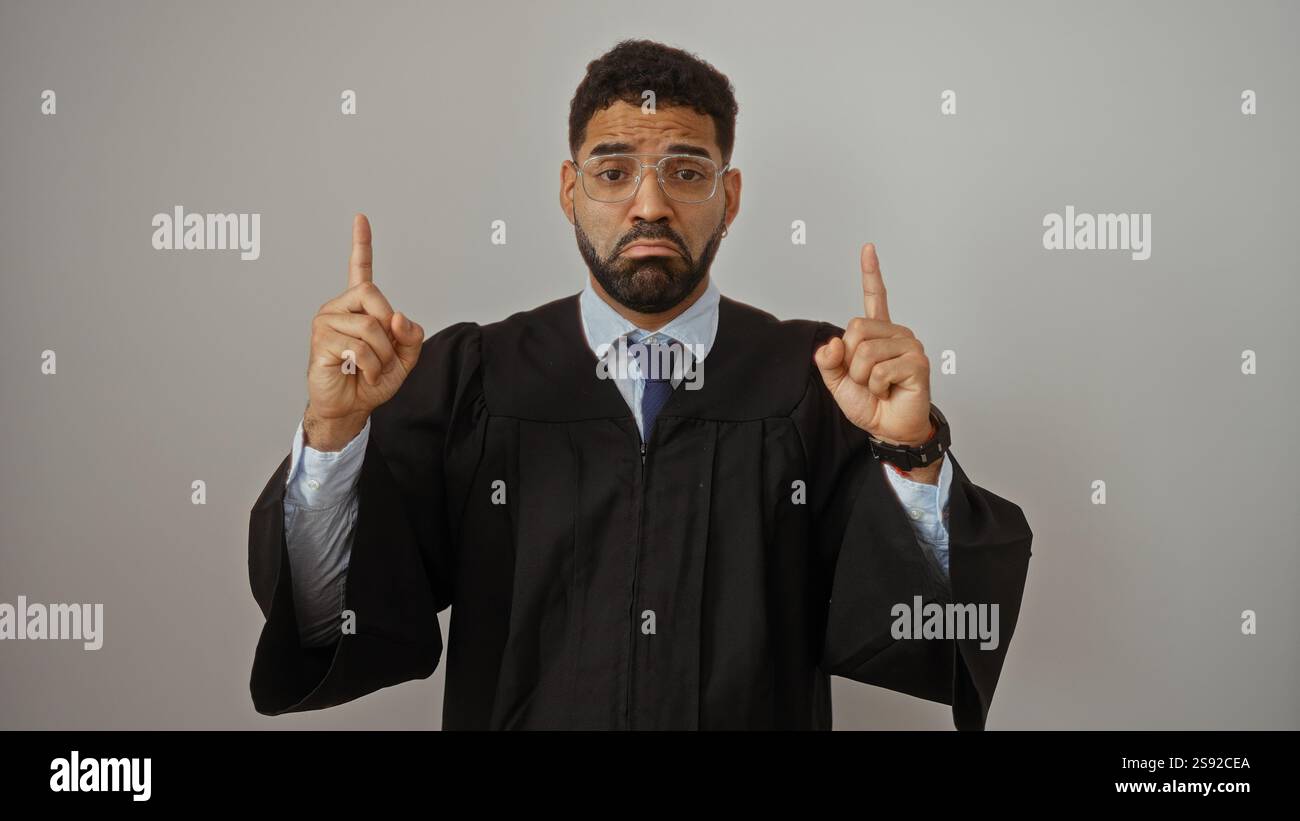 Hispanic man wearing glasses and a judge's robe, pointing upwards with ...