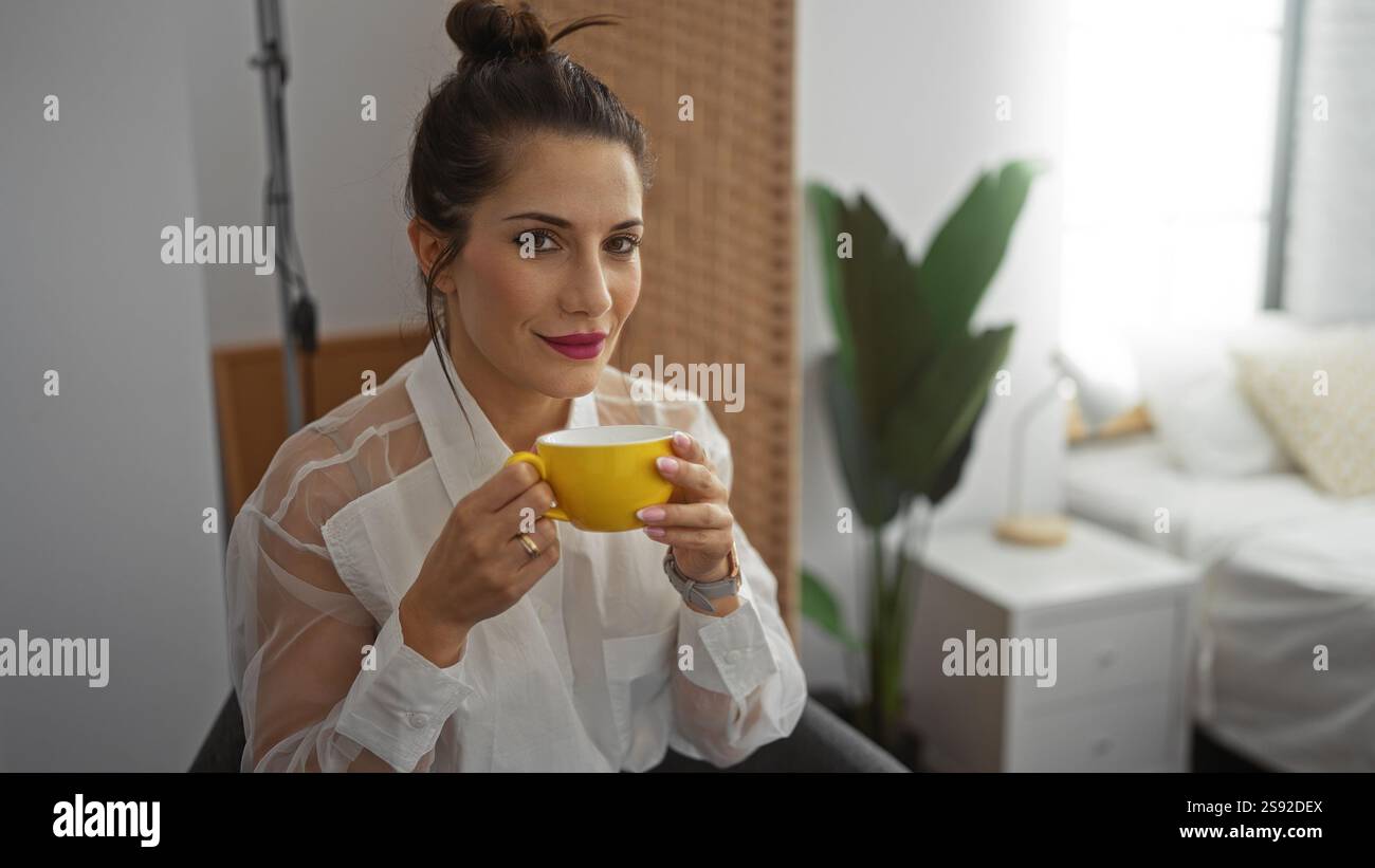 Woman enjoying coffee in a cozy bedroom with modern decor, smiling ...