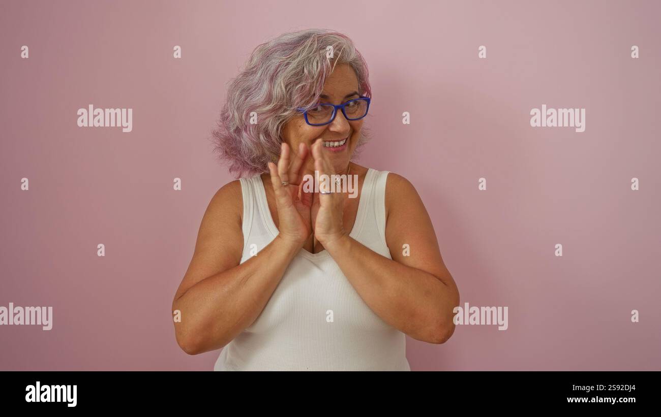 Smiling elderly hispanic woman with grey hair and glasses clapping ...