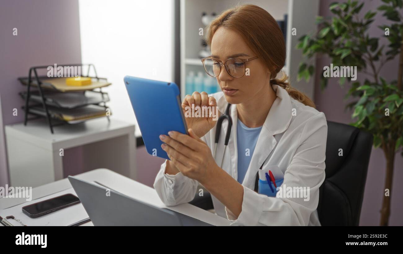 Woman doctor using tablet in modern hospital office, focused on screen ...
