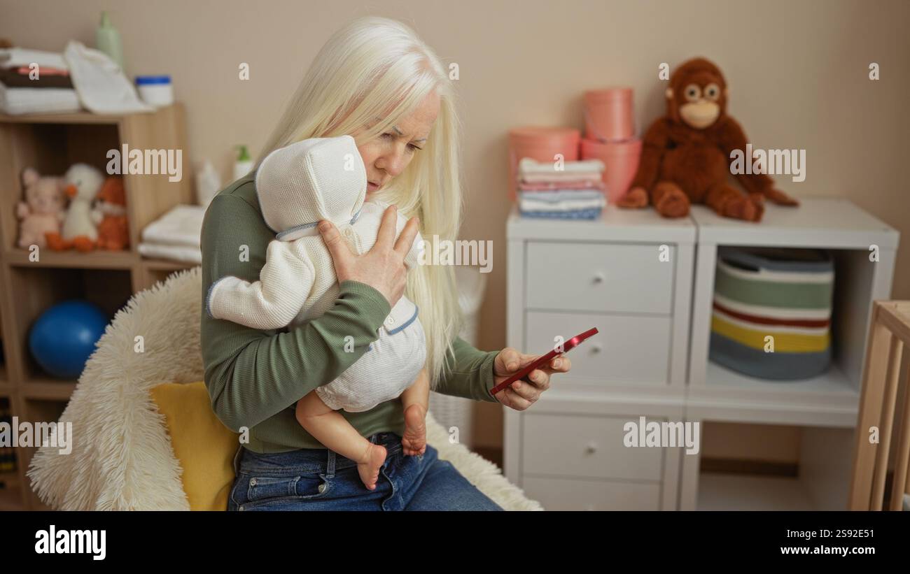 Woman with albinism holding baby in cozy bedroom checks smartphone ...
