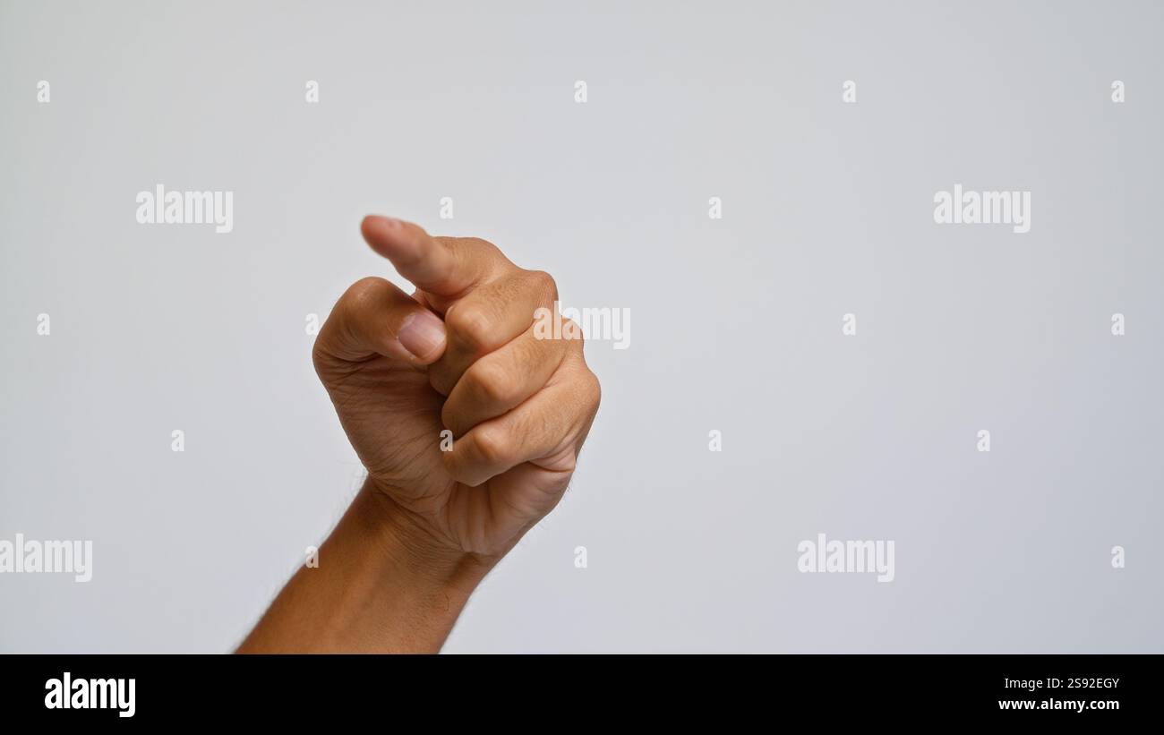 Man's hand pointing with a finger against a blank gray background ...