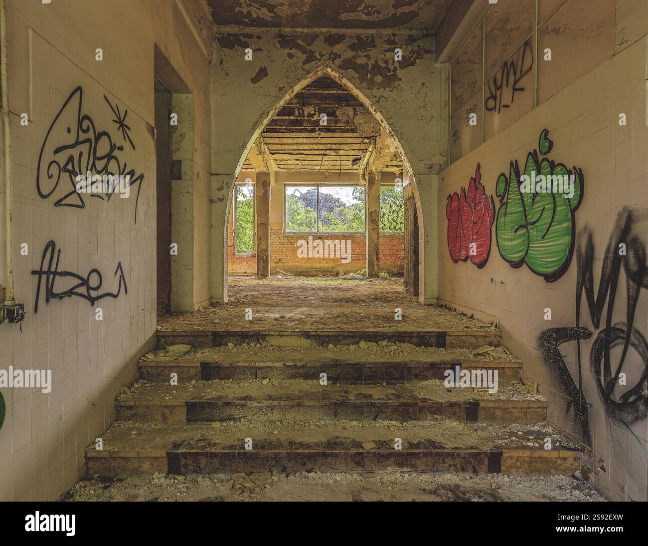 Entrance hall with crumbling arched structure, numerous graffiti ...