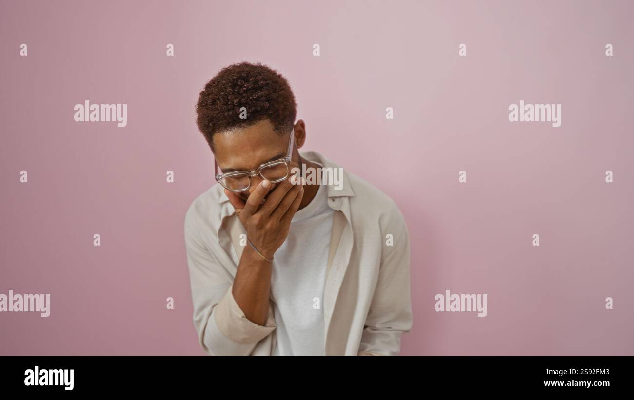 Handsome young african american man laughing with hand over mouth ...