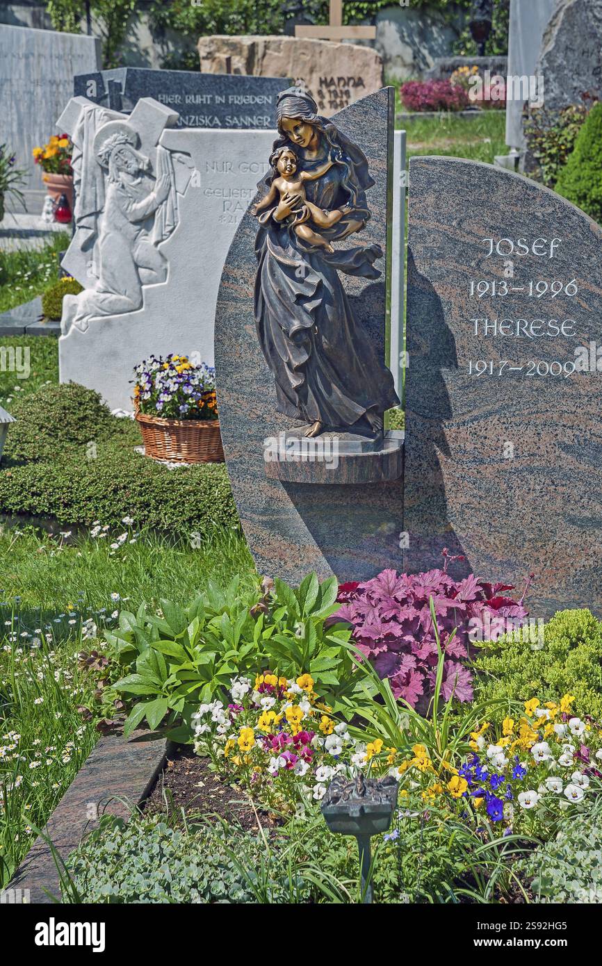 Graves with floral decorations at the cemetery church of St. Maria next ...