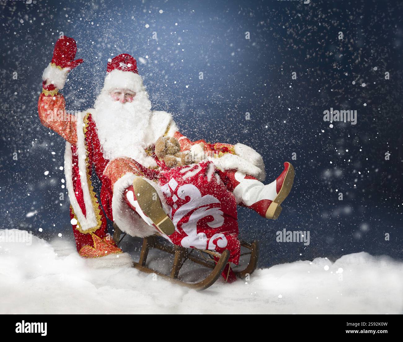 Father Christmas flies through the snow on his sleigh. Portrait in full ...