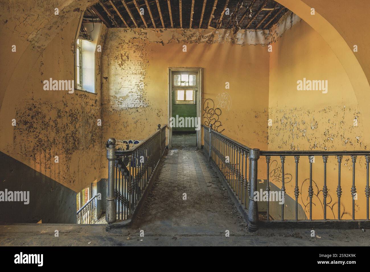 Old, abandoned corridor with railings and dilapidated walls, Prison H11 ...