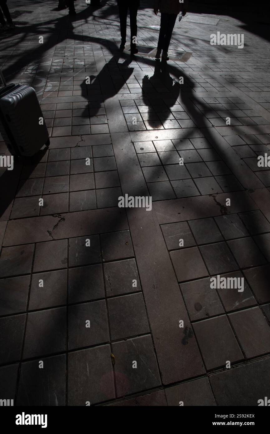 Shadows of two people walking on the ground Stock Photo - Alamy