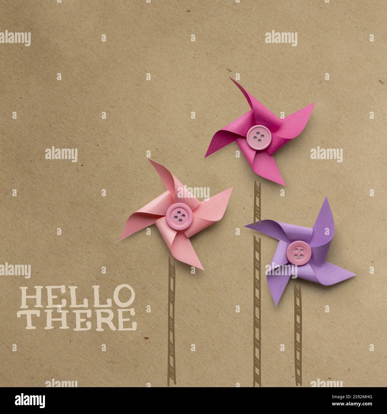 Creative concept photo of three paper windmills on a brown background ...