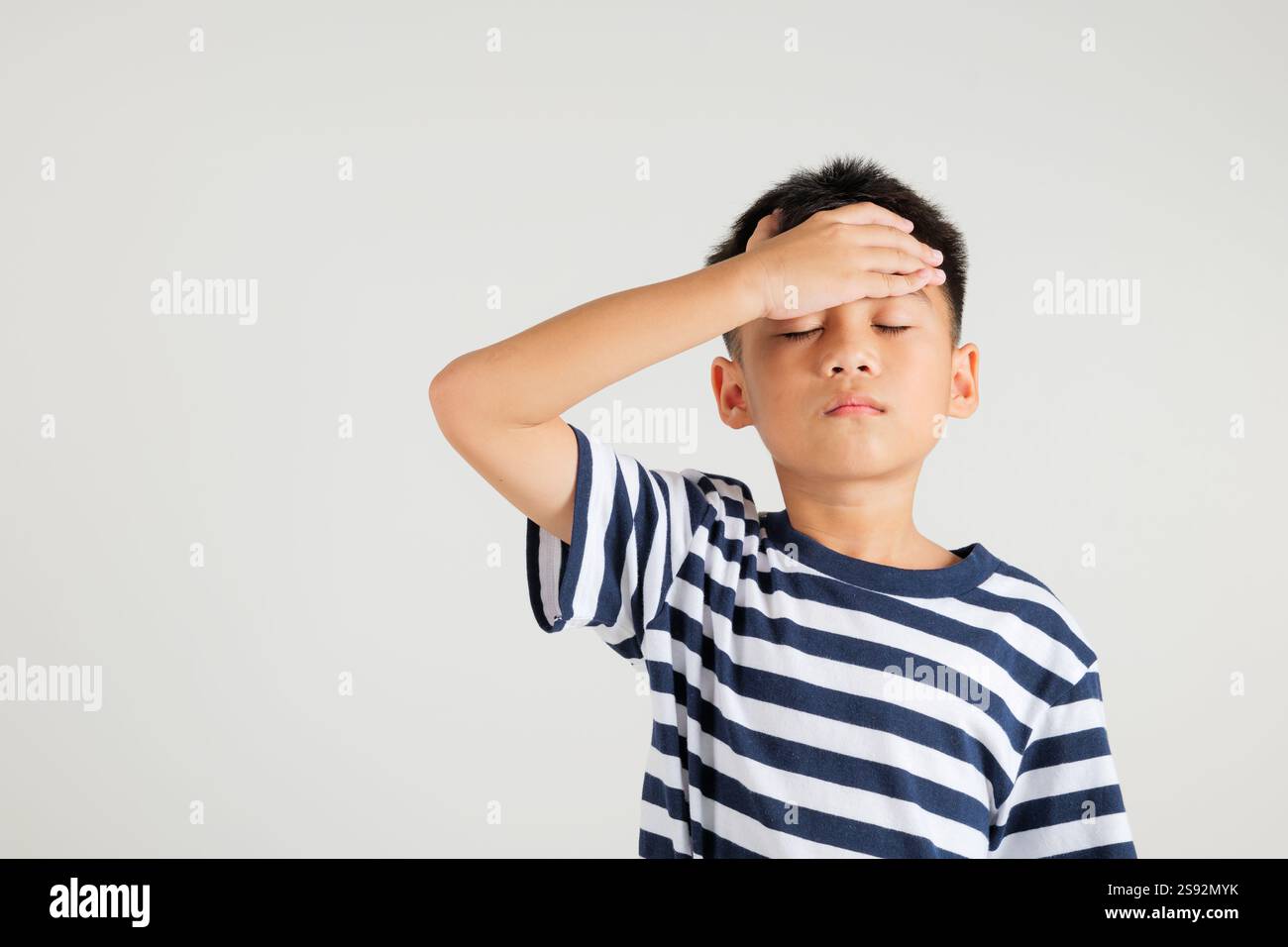 Portrait of Asian young kid boy sad tired strain face holding hold head ...