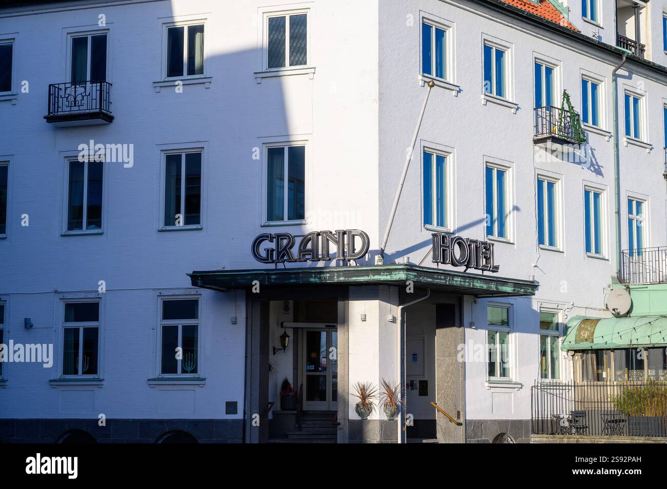 A well-maintained historic hotel presents modern architecture. The sun ...