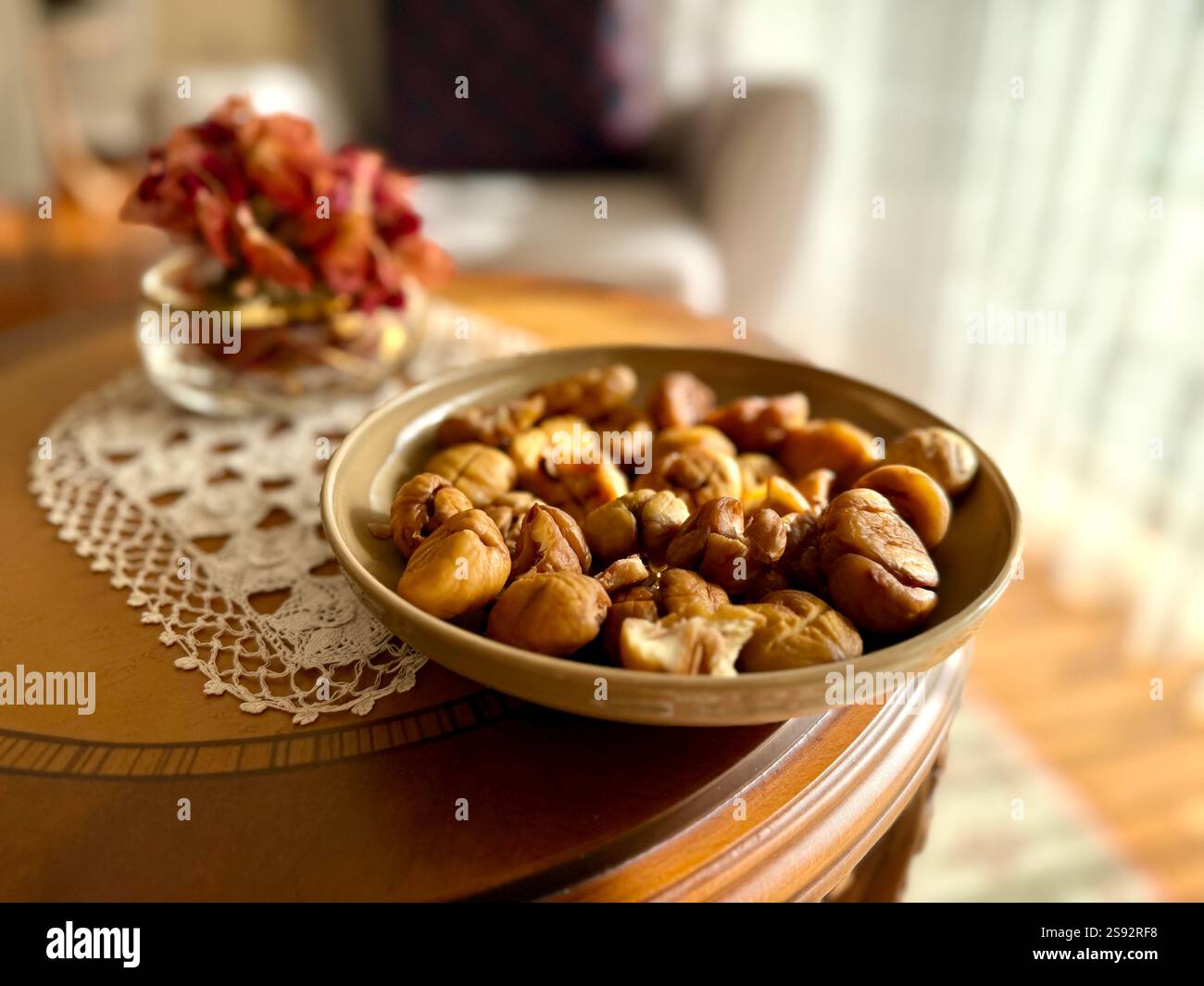 Roasted grilled chestnuts in plate ready to eat at home Stock Photo - Alamy