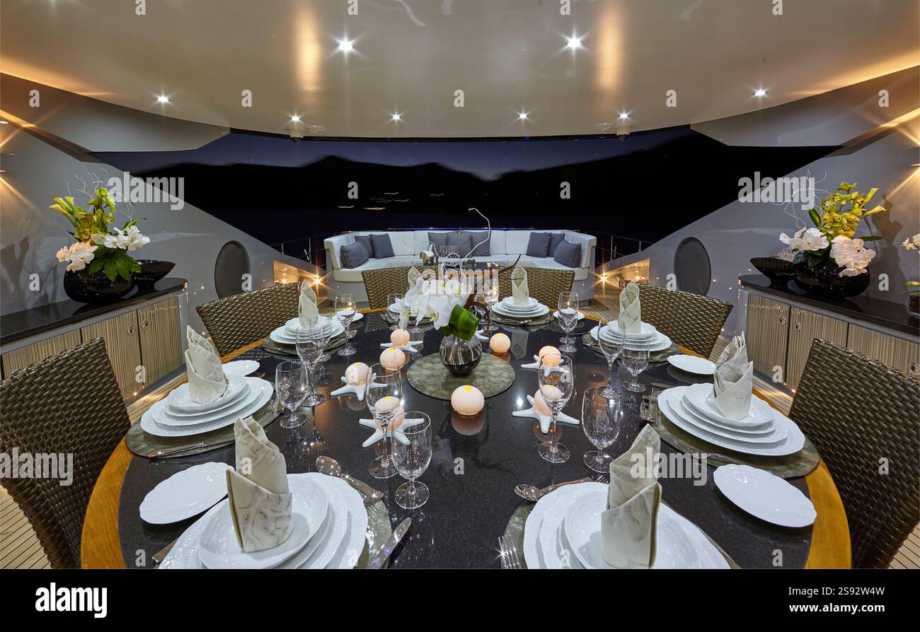 Luxurious Dining Area on a Yacht with Elegant Table Setting at Dusk ...