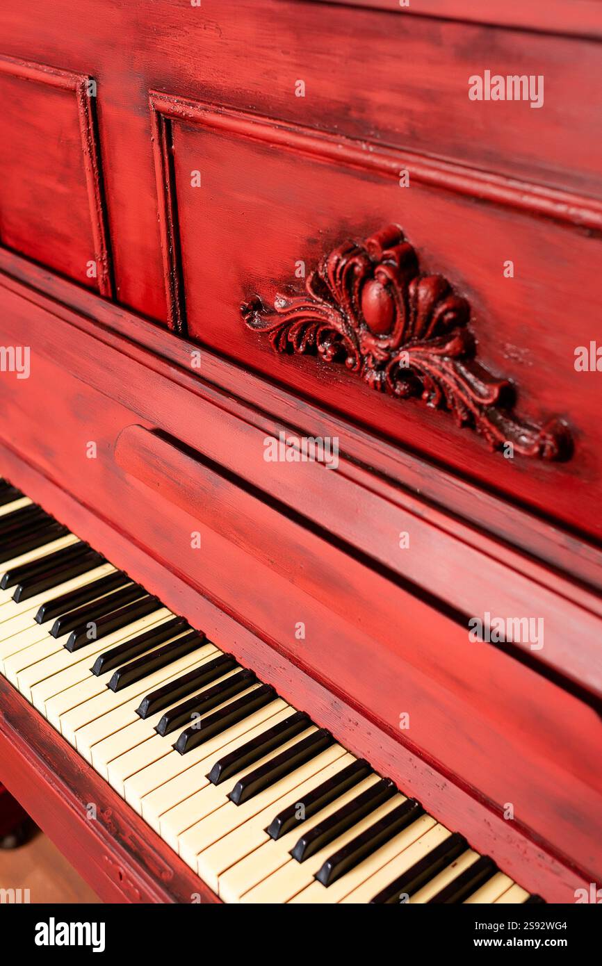 red piano with black and white keys. colored grand piano in photo zone ...
