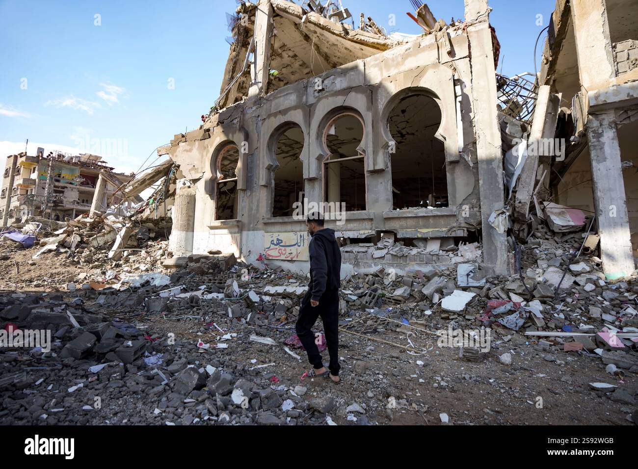A Palestinian walks inside a mosque destroyed by the Israeli airstrikes ...