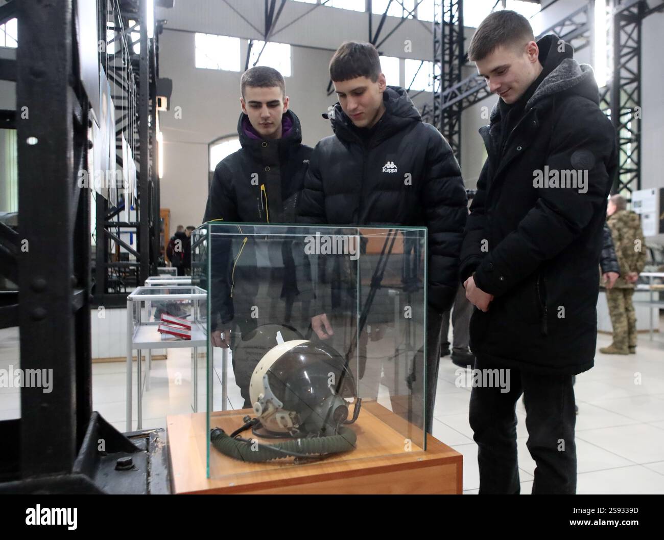 KYIV, UKRAINE - JANUARY 23, 2025 - Young men look at the flight helmet ...