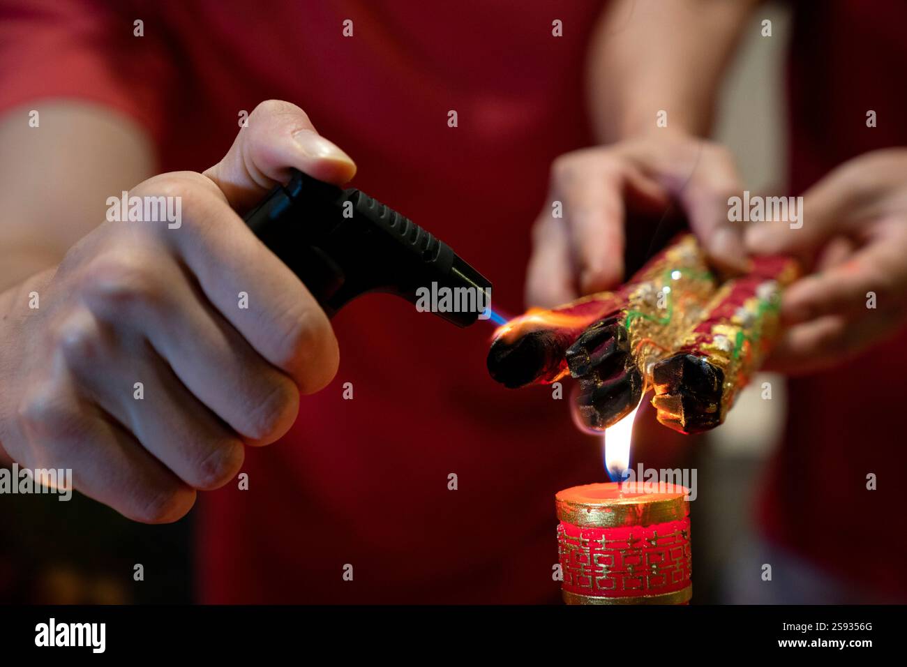 Hand holding joss sticks and candle as prayer and offering to the Gods ...