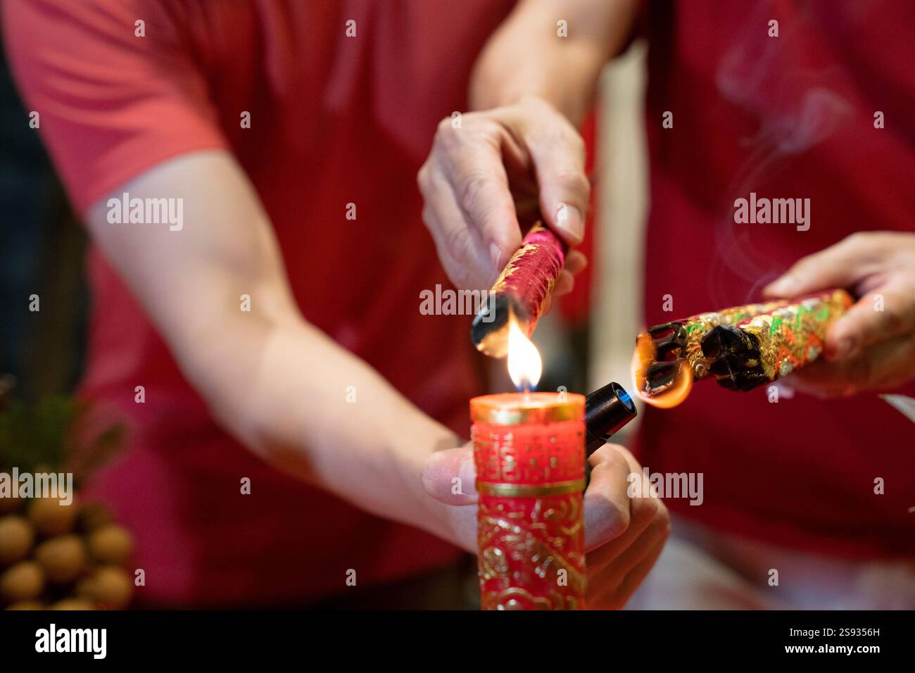 Hand holding joss sticks and candle as prayer and offering to the Gods ...