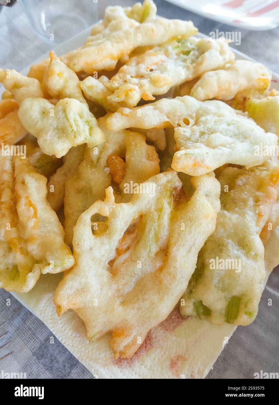 Battered and fried zucchini flowers, typical italian appetizer or side ...