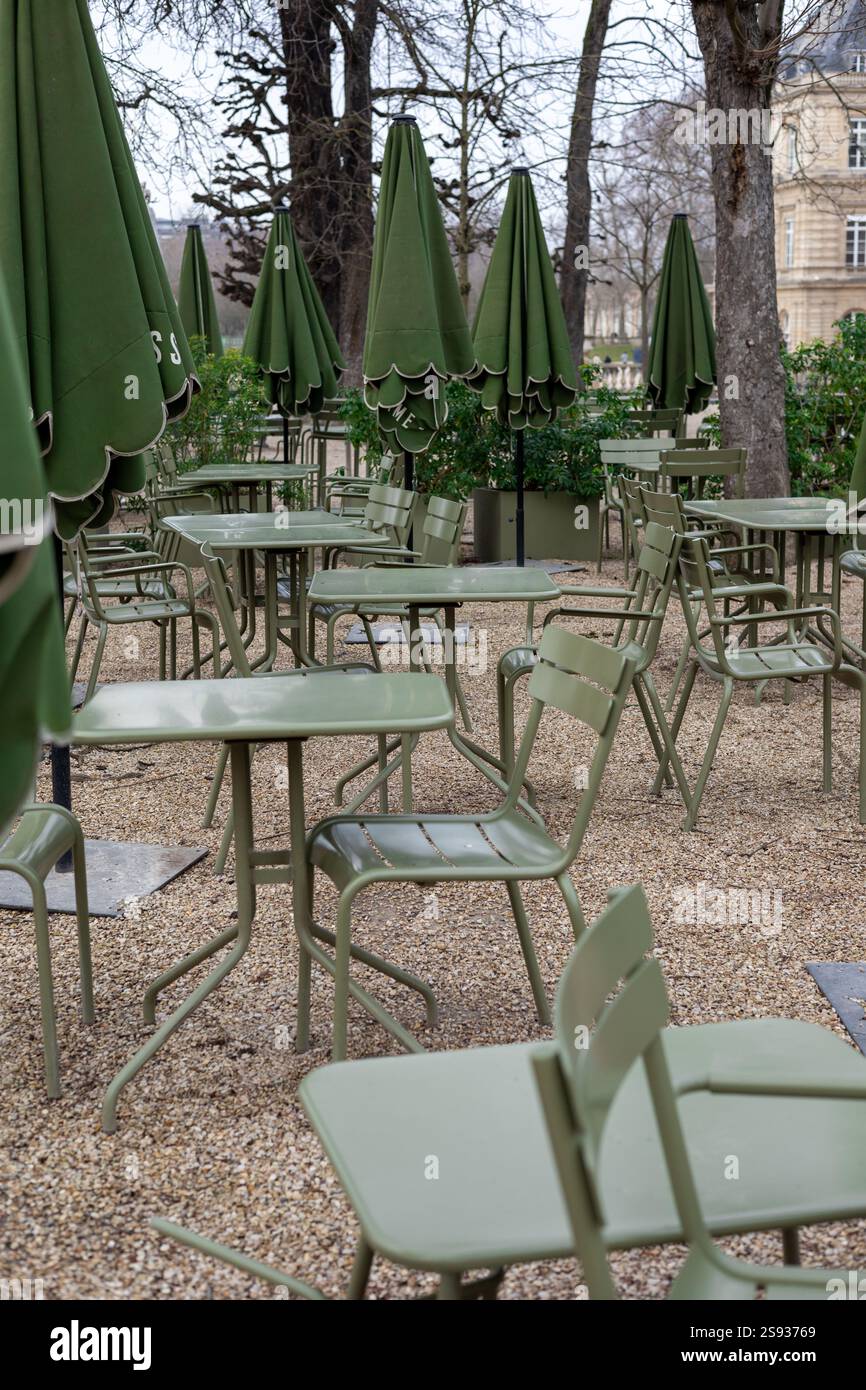 Outdoor seating area with green umbrellas and tables in a park during ...