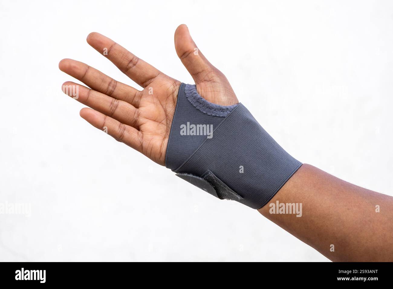Female hand with a wrist brace and thumb, isolated on a white ...
