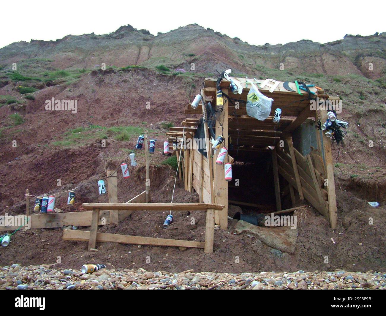 Shack built from driftwood at the base of an unstable cliff on the Isle ...