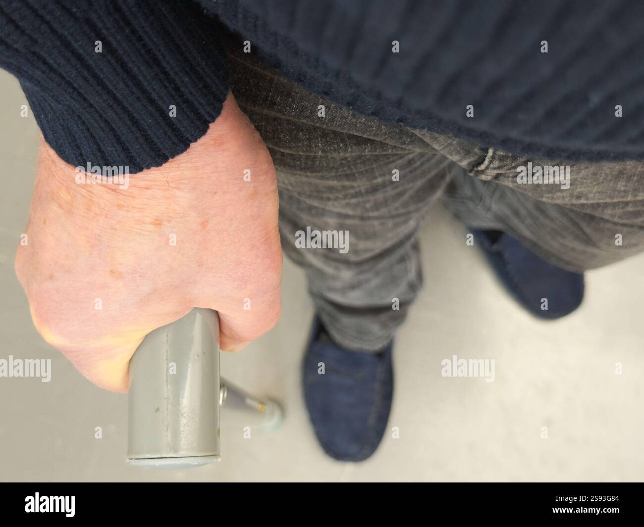 Closeup top down shot of a senior man in slippers, standing on an ...