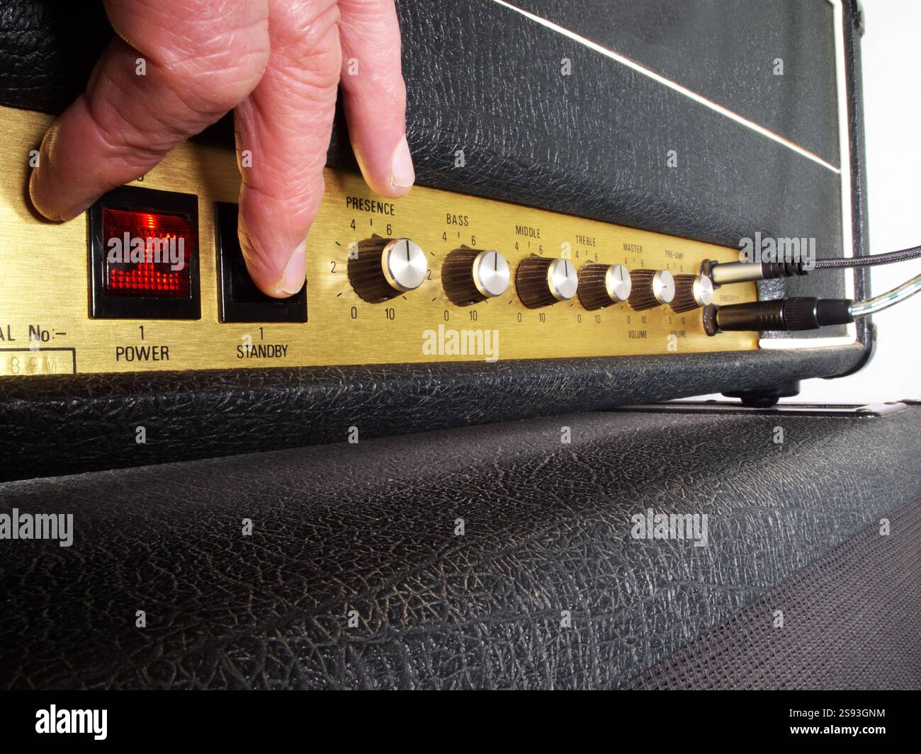 Closeup of a man’s finger pressing the power standby switch on a ...