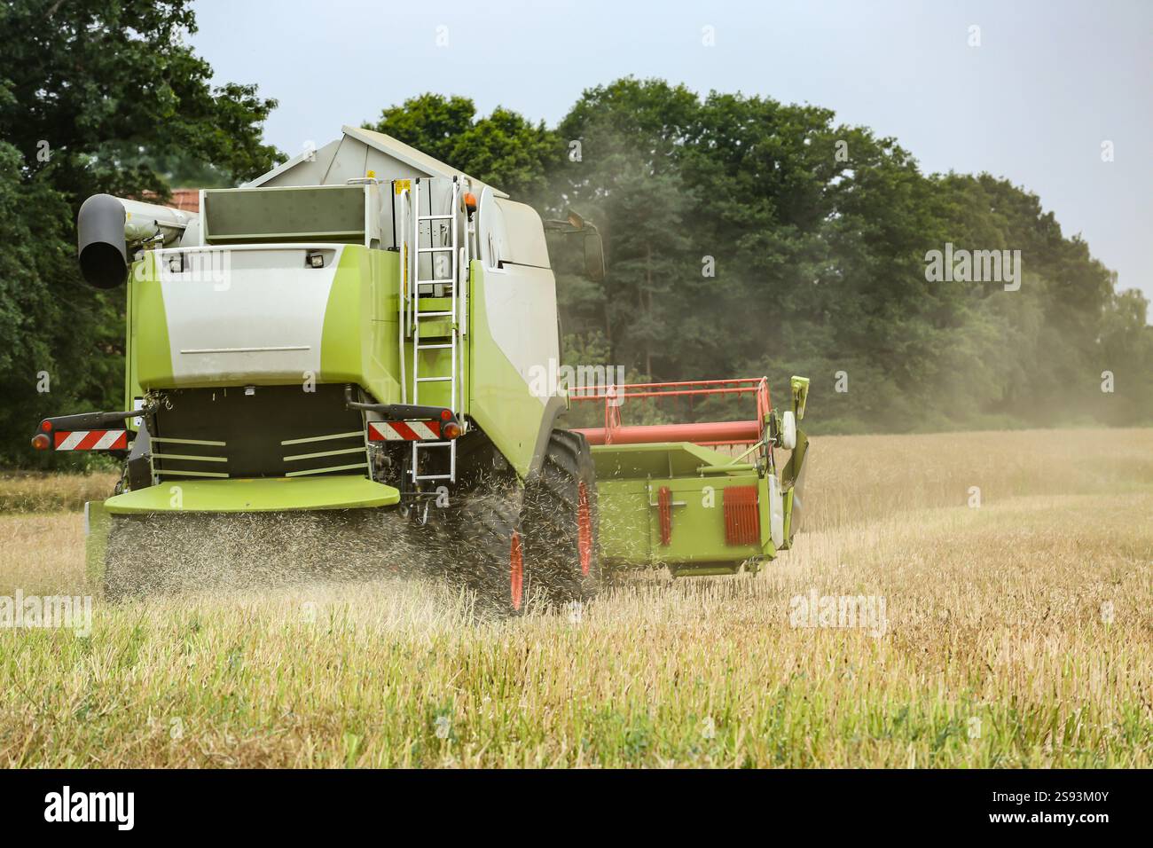 big combine harvester in the field Stock Photo - Alamy