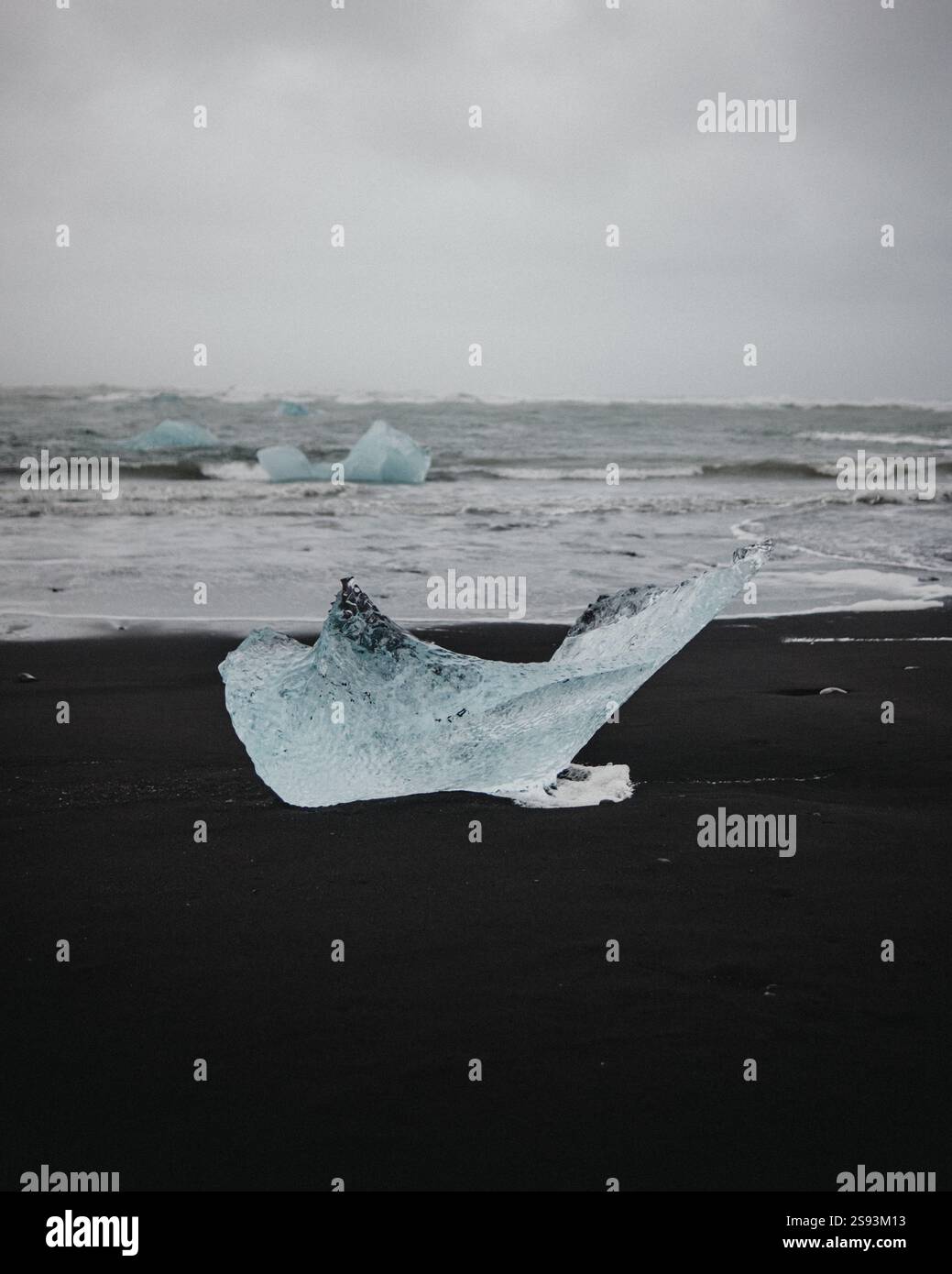 Striking blue ice shard on black sand at Diamond Beach, South Iceland ...