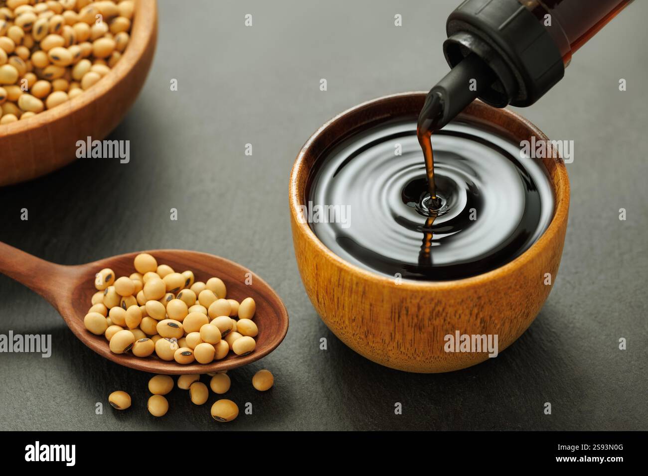 soy sauce pouring from bottle in bowl with splash and drop and dry ...